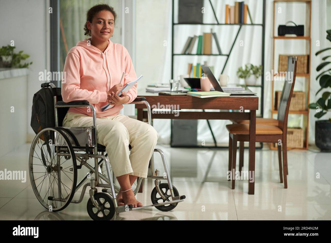 Portrait of teenage girl with disability studying at home Stock Photo ...