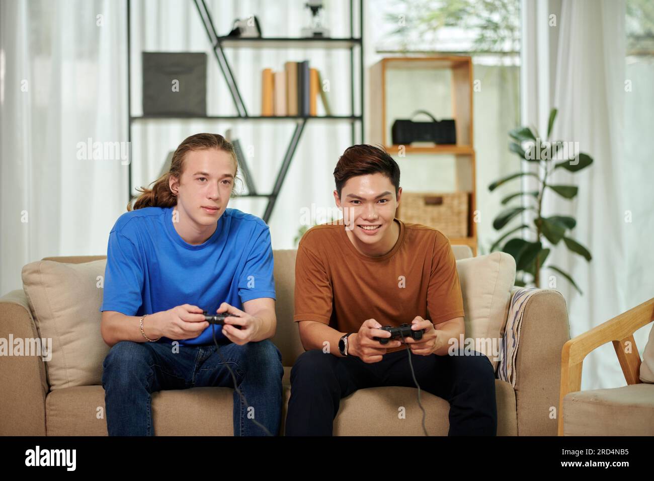Best friends playing videogame together at home Stock Photo - Alamy