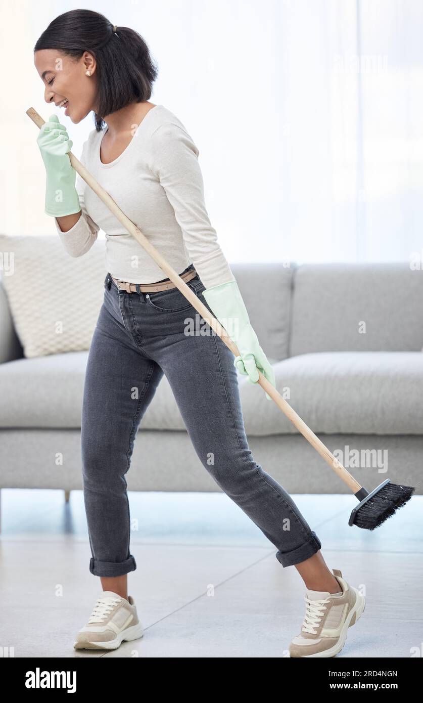 Singing, dance and woman with broom at home for cleaning, hygiene and weekend routine. Music ...