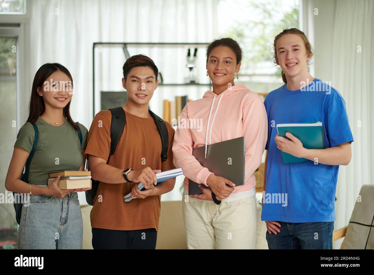 Group of cheerful diverse college students with books and laptop Stock ...