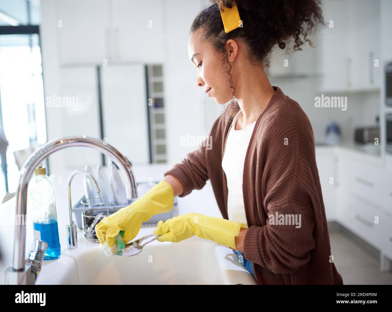 Woman washing dishes in kitchen, cleaning and housework with hygiene ...