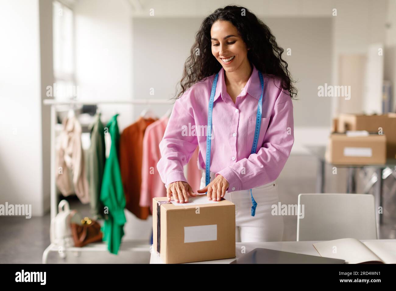 Happy Dressmaker Woman Enjoying Packaging Process in Fashion Showroom ...