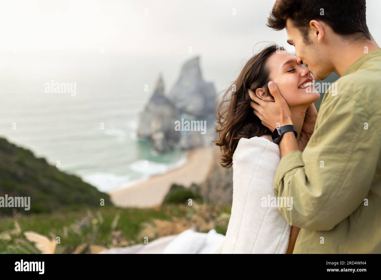 Maritime magic. Loving couple having date on the rocks with beautiful ...