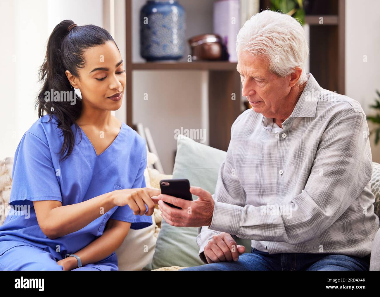 Nurse, woman and elderly patient with a smartphone, couch or connection ...