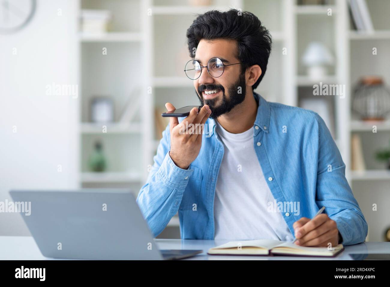 Smiling Indian Man Using Loudspeaker Mode While Talking On Cellphone ...