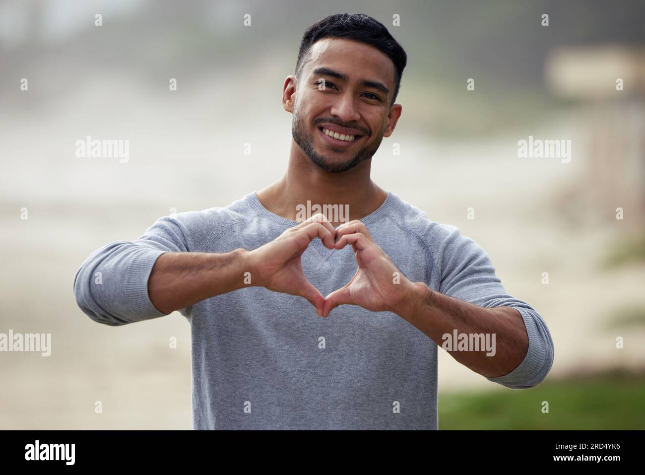 Portrait of happy man, heart and hand outdoor for care, kindness and ...