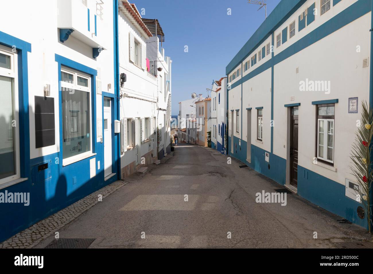 Colourful house facades in an alley in Praia do Burgau, Faro district ...
