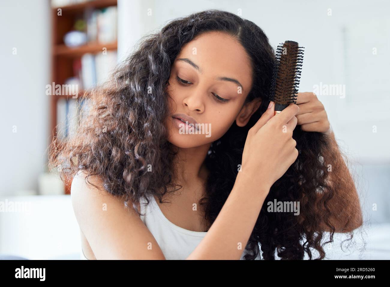 Brushing hair woman and morning routine at home with care and grooming. Bathroom relax female person and curly hairstyle knots holding a brush in a Stock Photo Alamy