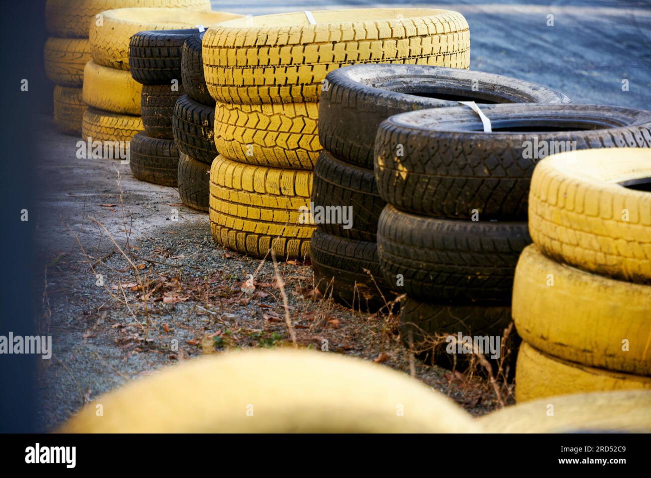Stack of car tires black and yellow, for racing track fencing Stock ...