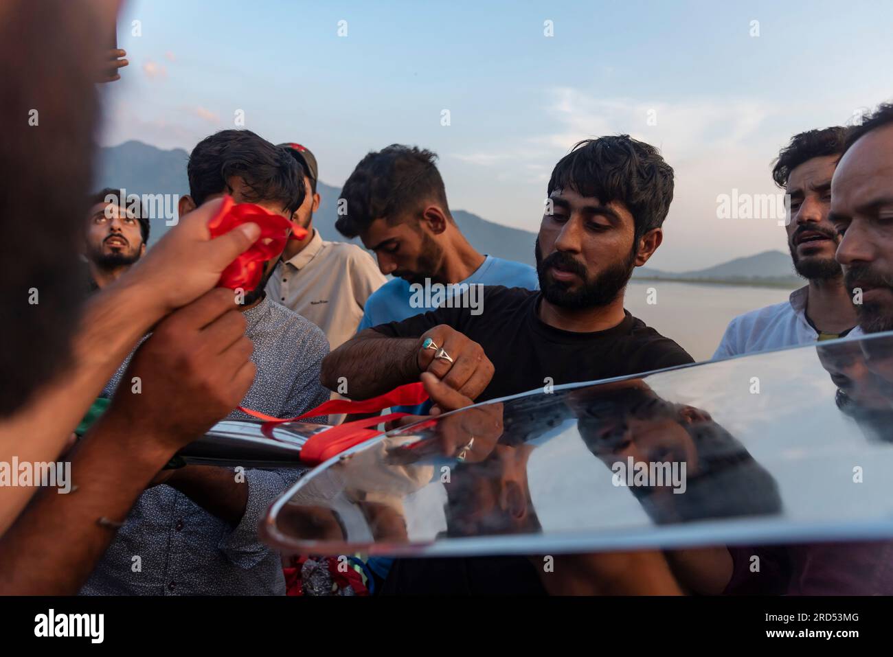 Srinagar, India. 18th July, 2023. Shia Muslims hold an Alam (religious ...
