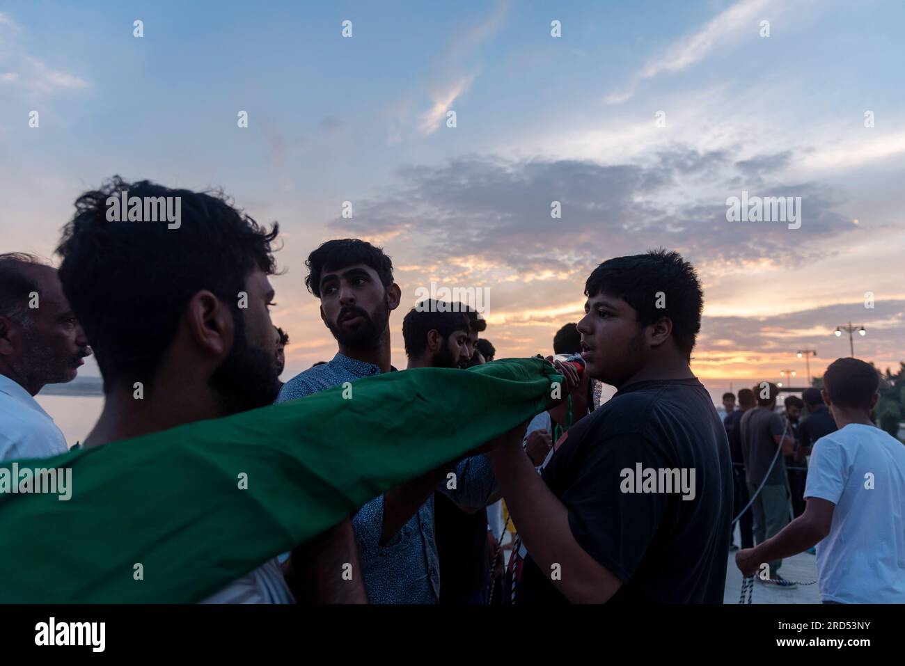 Srinagar, India. 18th July, 2023. Shia Muslims hold an Alam (religious ...