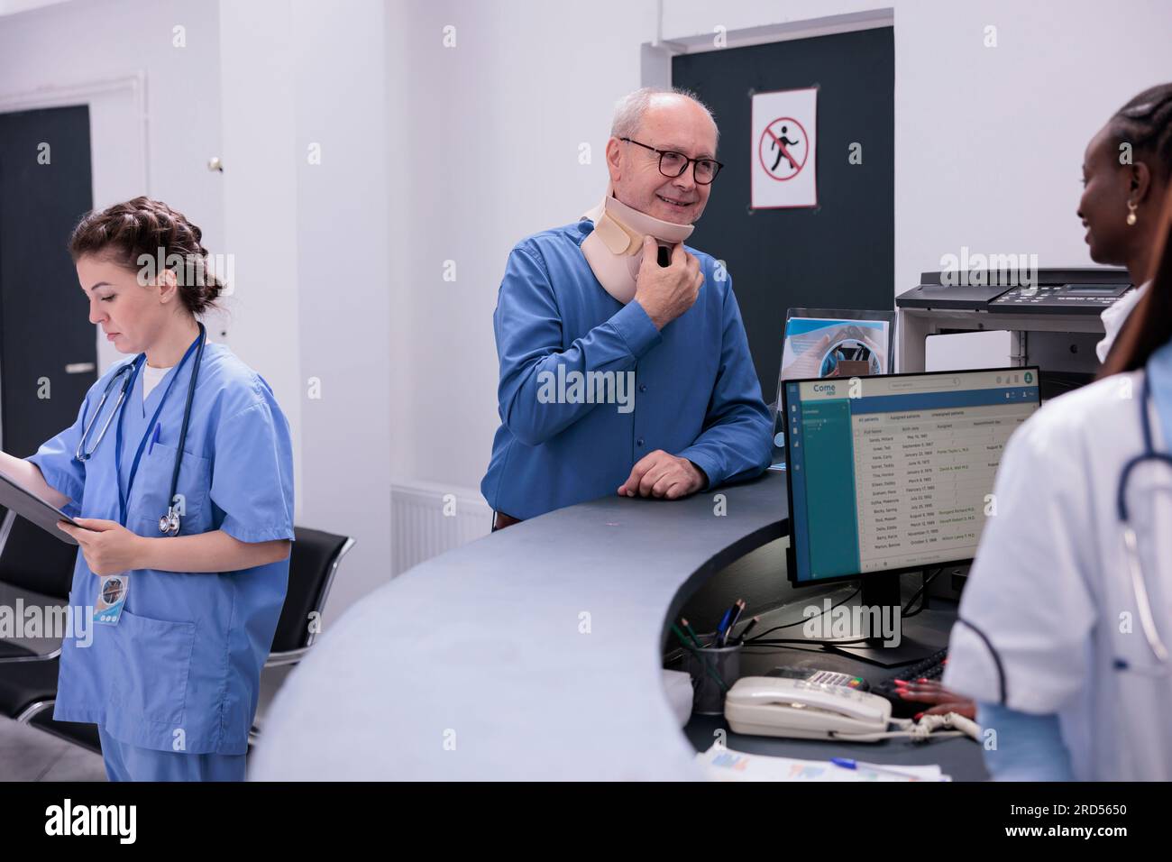 Injured senior patient with cervical neck collar standing at hospital ...