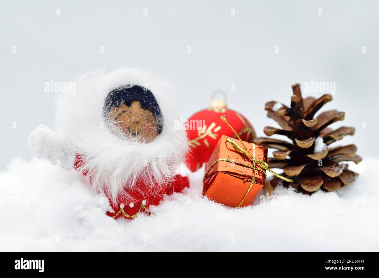Christmas decoration, Inuit with Christmas tree ball and pine cone and ...
