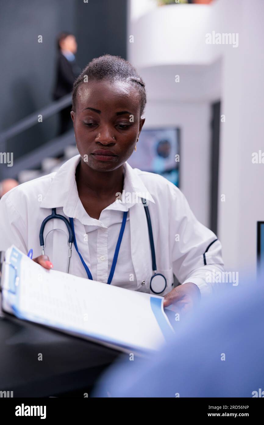 Doctor giving patient documents hi-res stock photography and images - Alamy