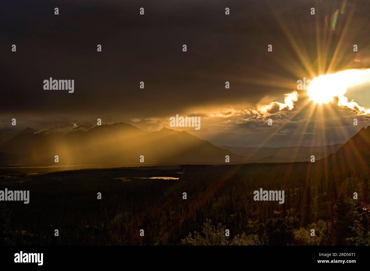 Sun in the evening breaks through the dense cloud cover in the ...