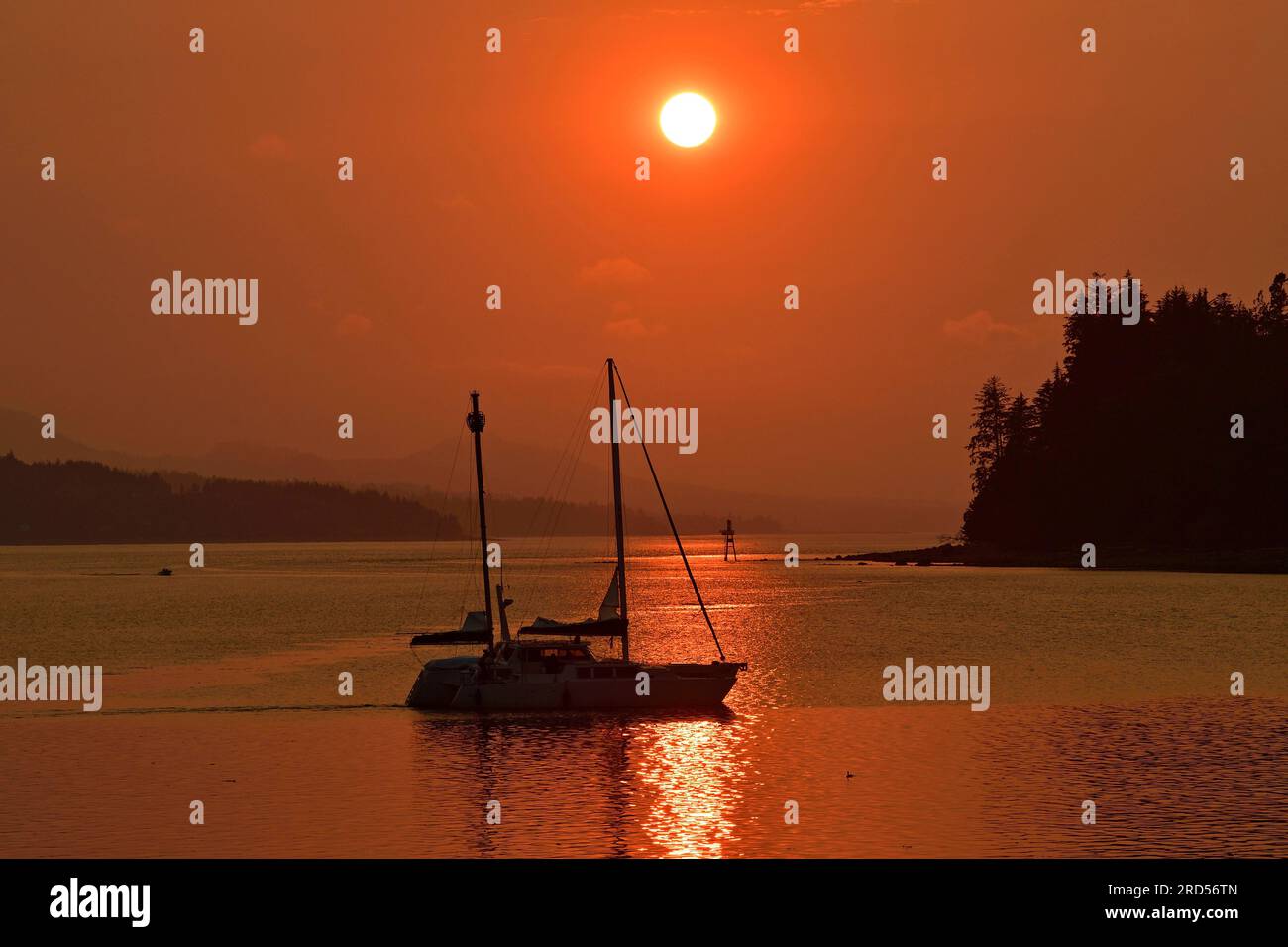 Sailing ship sailing along the Pacific coast in the sunset, Vancouver ...