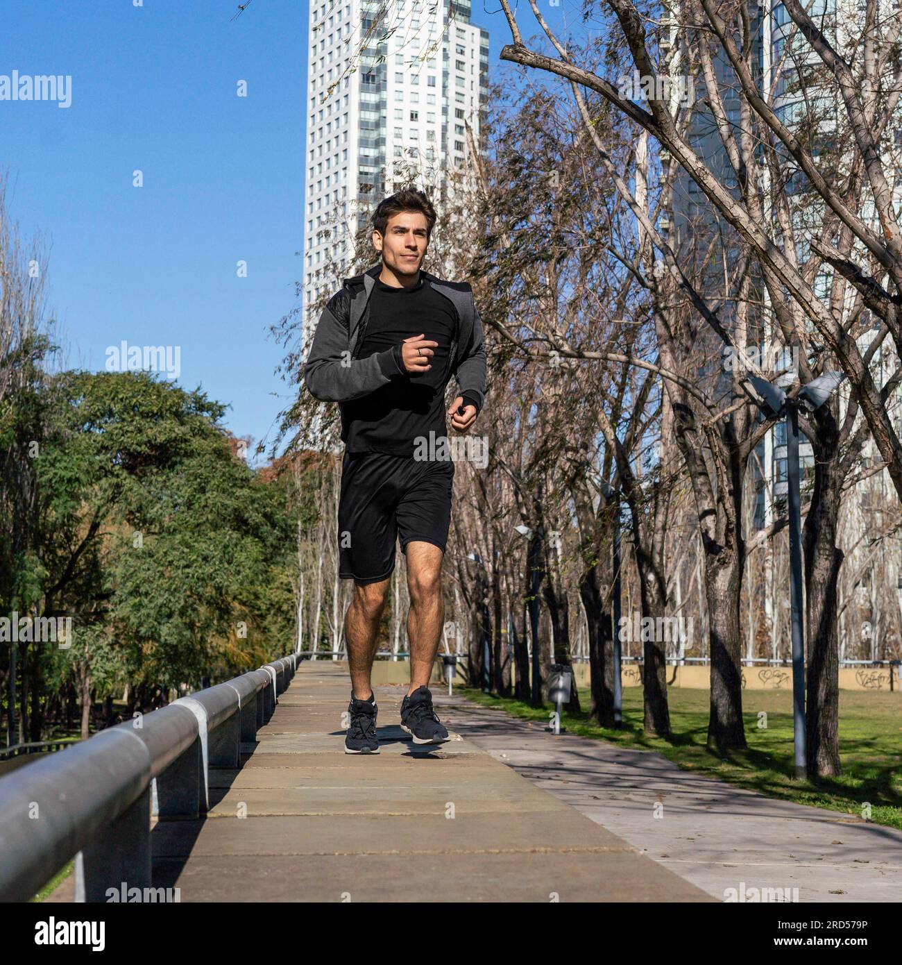 Fitness athlete runner jogging on park sidewalk Stock Photo - Alamy