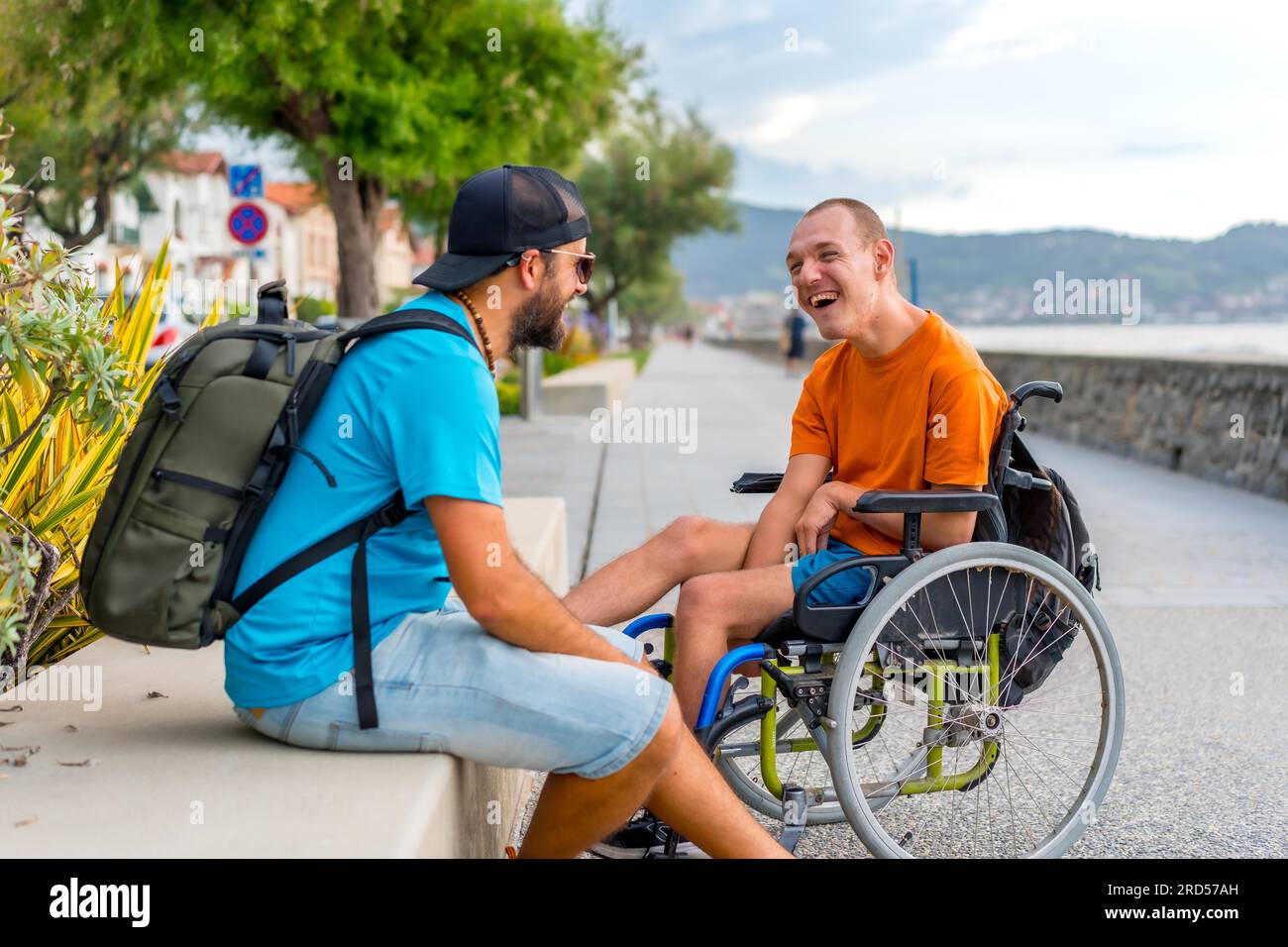 Disabled person in wheelchair with friends on summer vacation having ...