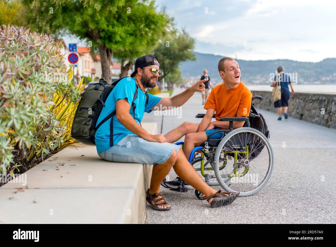 Disabled person in wheelchair with friends on summer vacation having ...