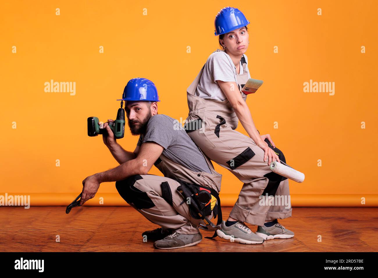 Interior constructors acting confident with building tools, posing on ...