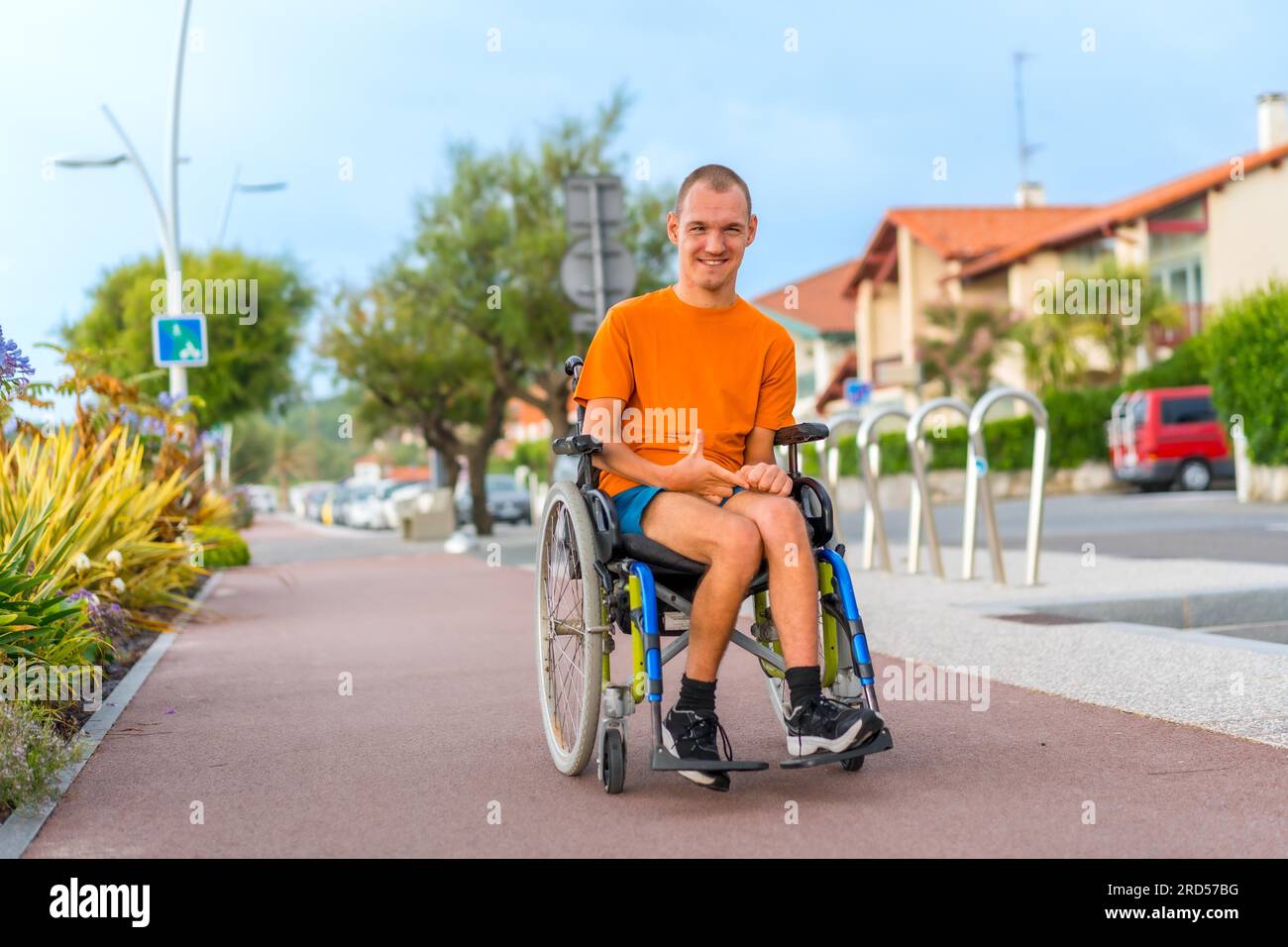 Portrait of a very cheerful disabled person in a wheelchair on vacation ...
