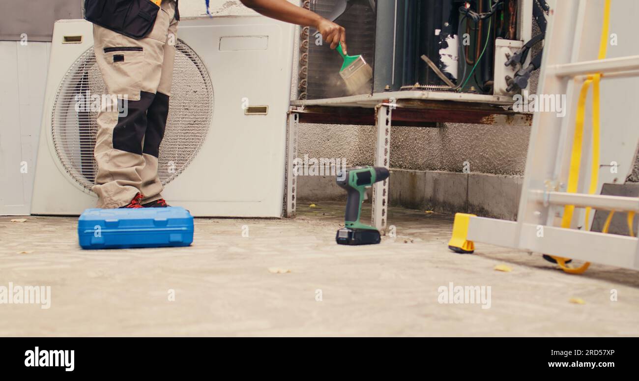 Ground level shot of trained engineer commissioned by home owner for ... Ground level shot of trained engineer commissioned by home owner for ...