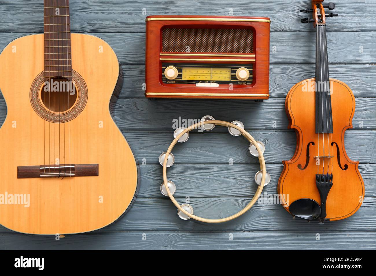 Different musical instruments and retro radio receiver on wooden ...