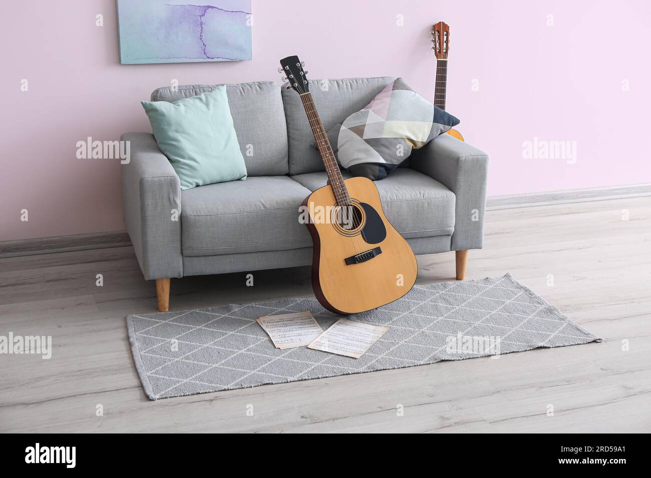 Interior of room with sofa and guitars Stock Photo - Alamy