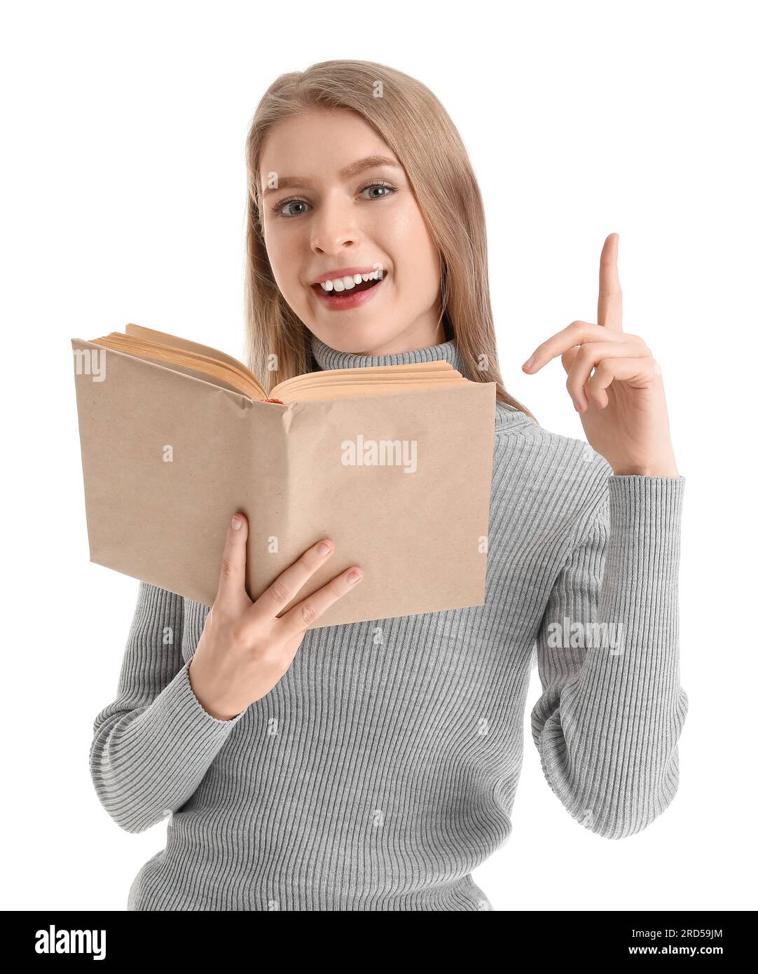 Young woman with open book pointing at something on white background ...