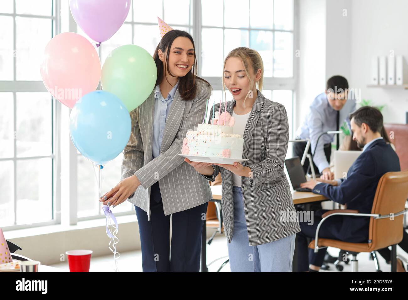 Female colleagues with Birthday cake at party in office Stock Photo - Alamy