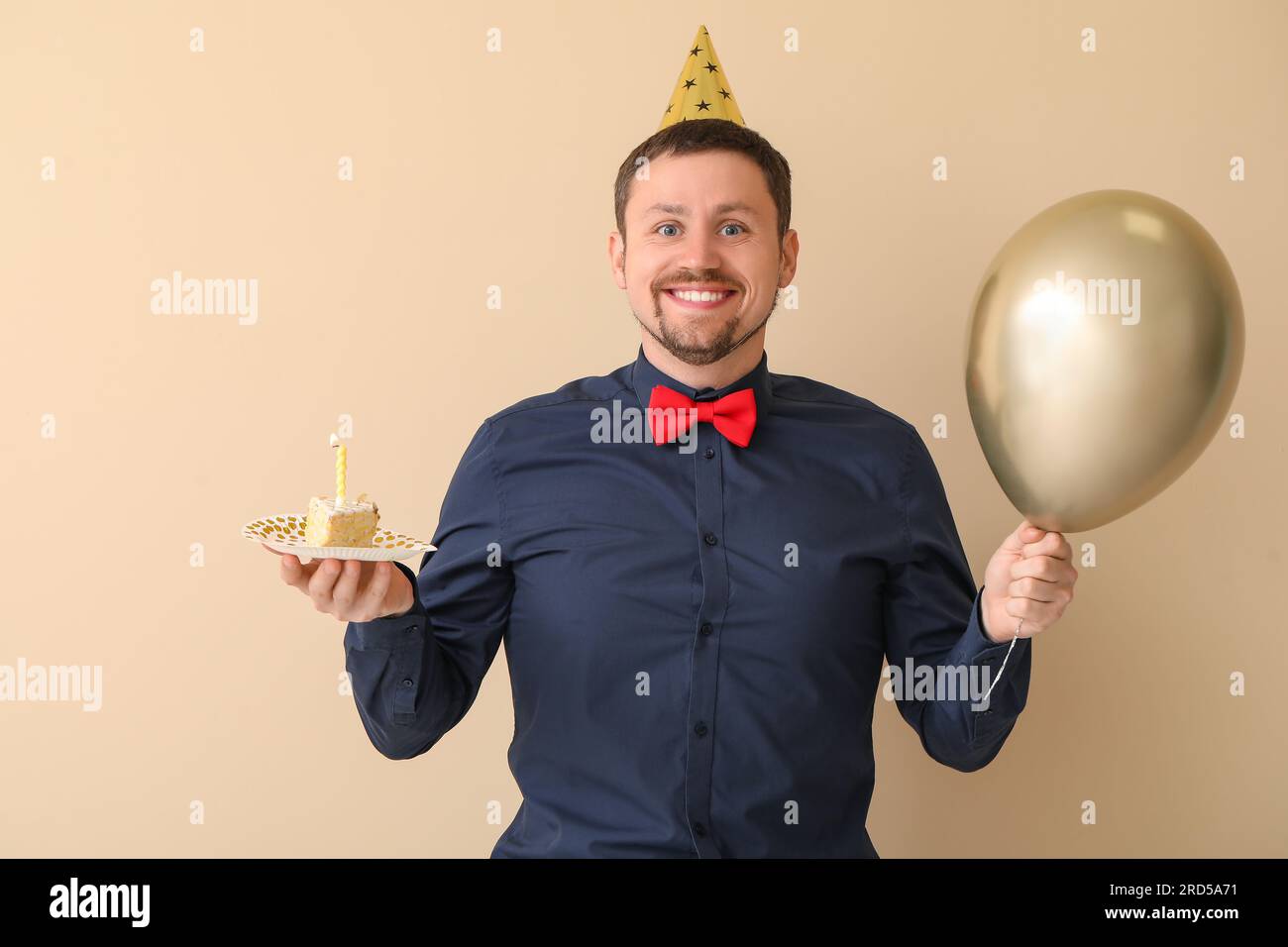 Happy man with birthday cake and balloon on beige background Stock ...
