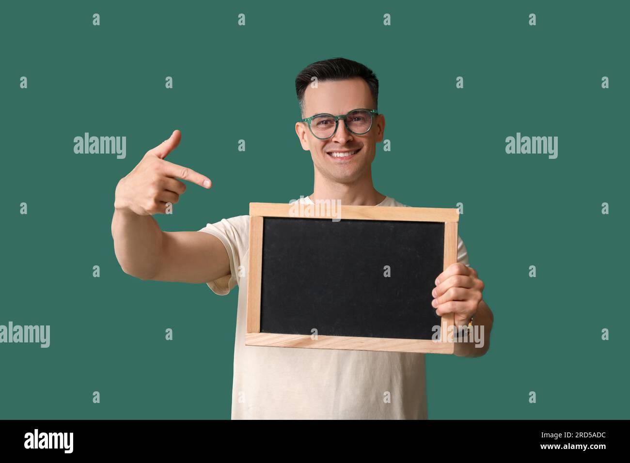 Teacher pointing green chalkboard hi-res stock photography and images ...