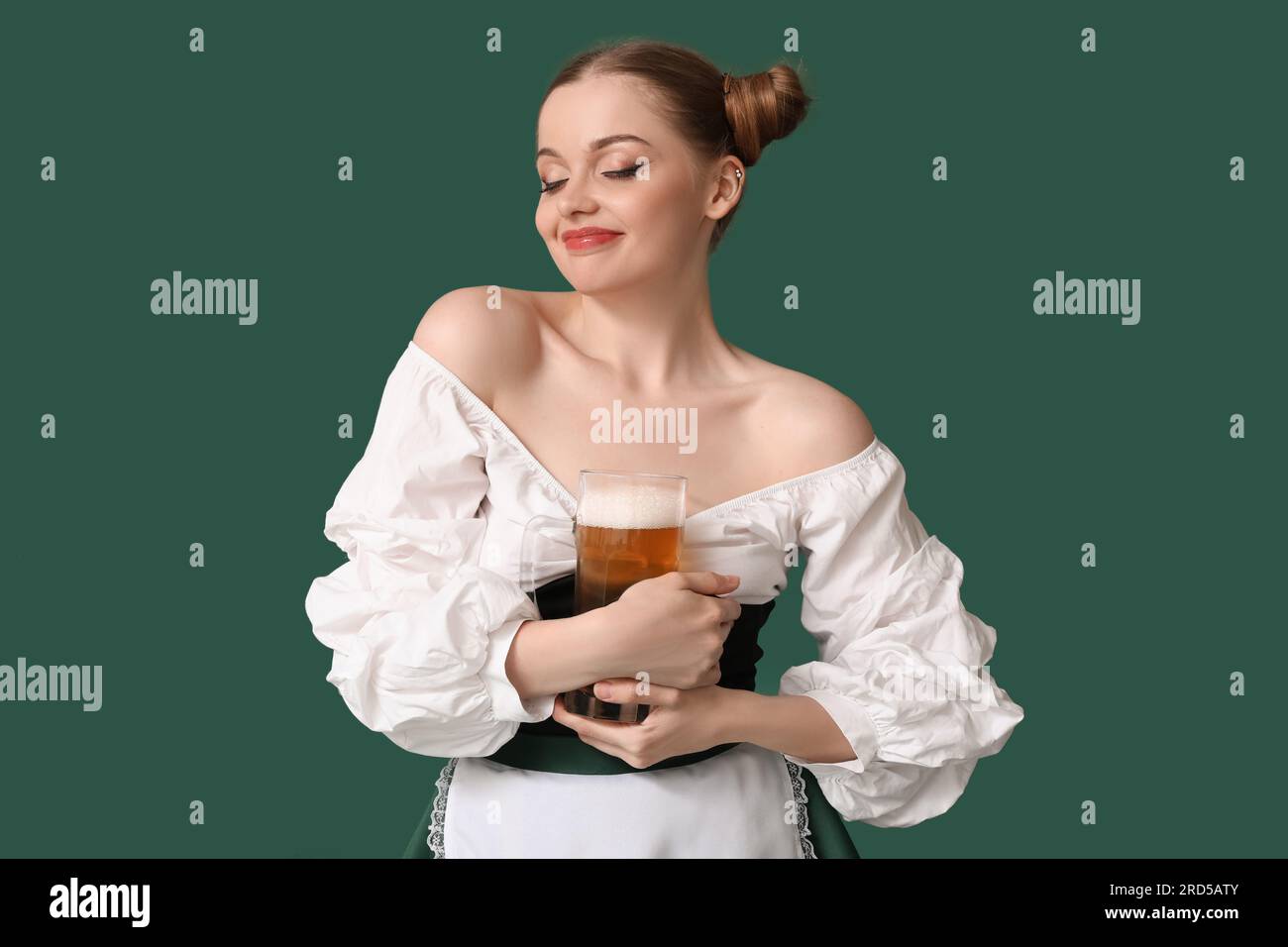 Beautiful Octoberfest waitress with beer on green background Stock ...