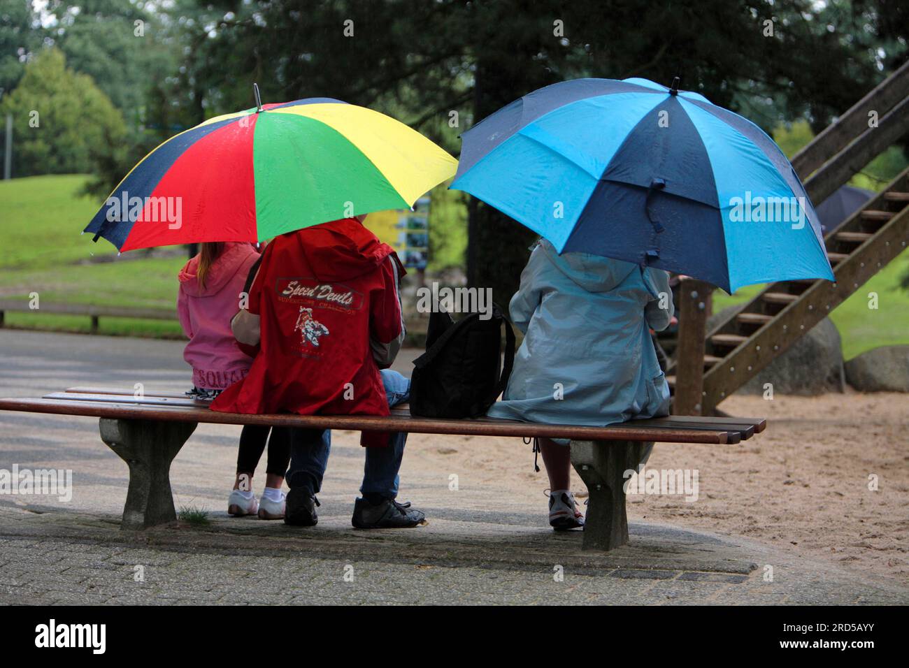 People on park bench with umbrellas, Emmen Zoo, rain, Netherlands Stock ...