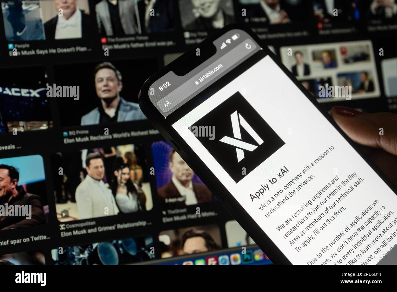 In this photo illustration, A person browses website of xAI, displayed ...