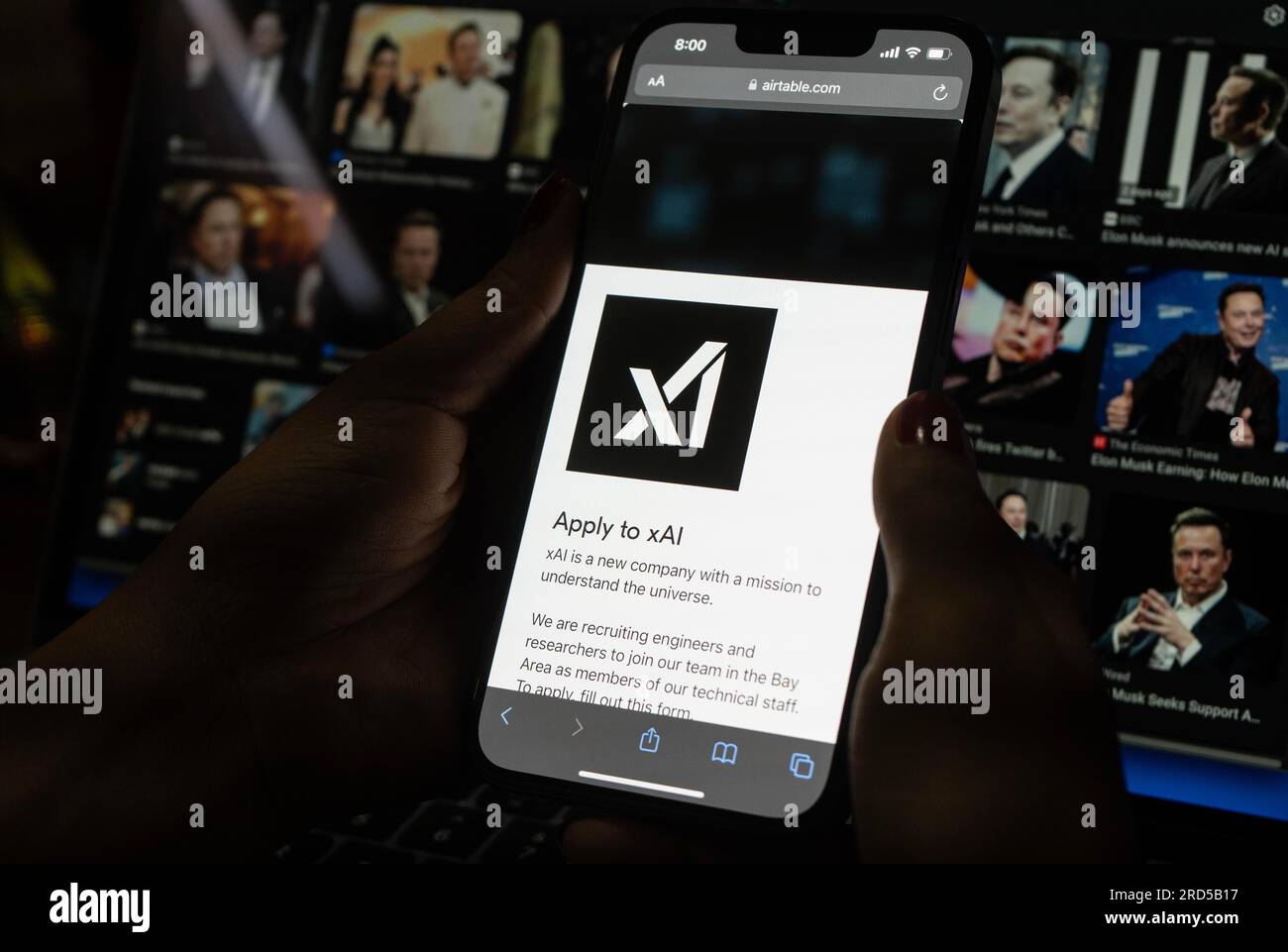 In this photo illustration, A person browses website of xAI, displayed ...