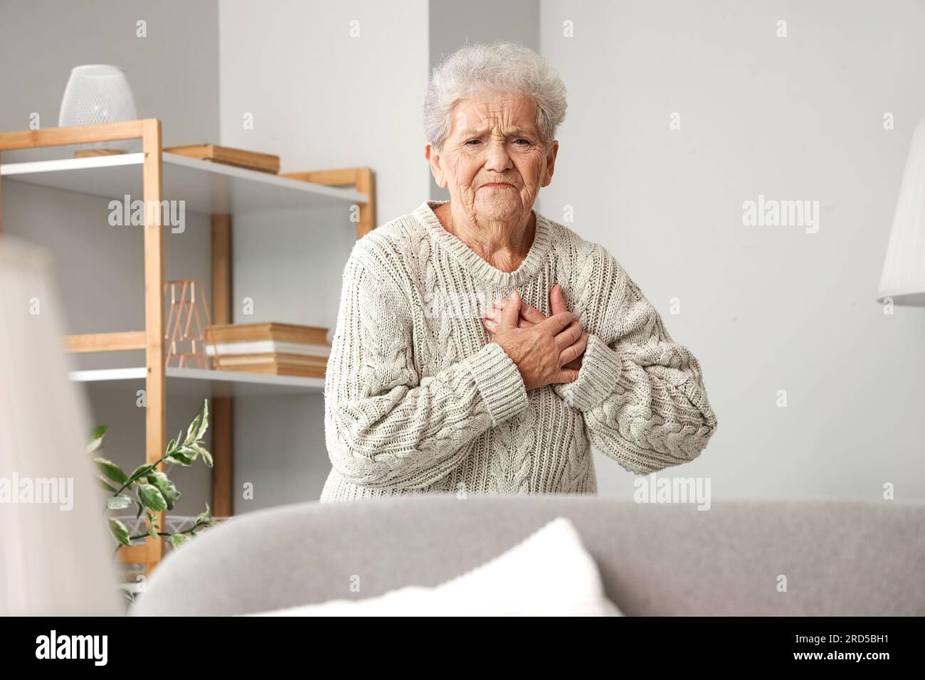 Senior woman having heart attack at home Stock Photo - Alamy