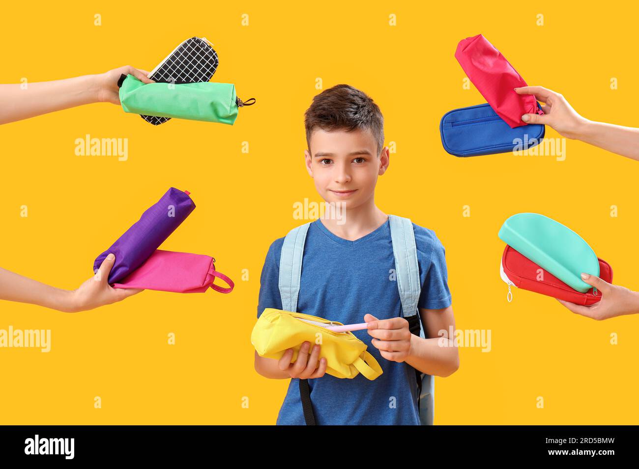 Little schoolboy and female hands with pencil cases on orange ...
