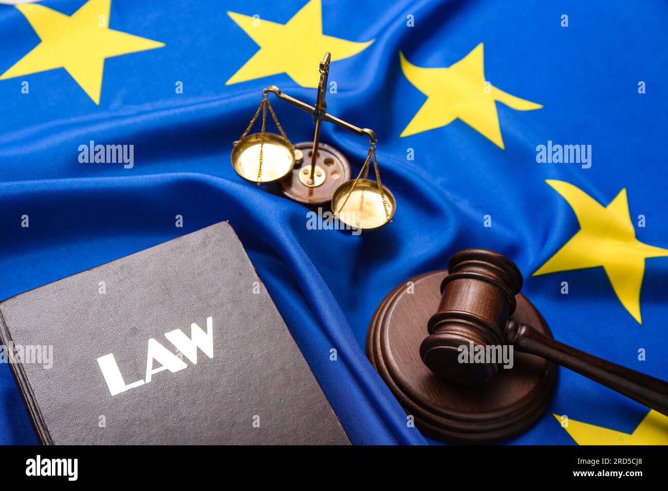 Law book, scales of justice and judge's gavel on European Union flag ...