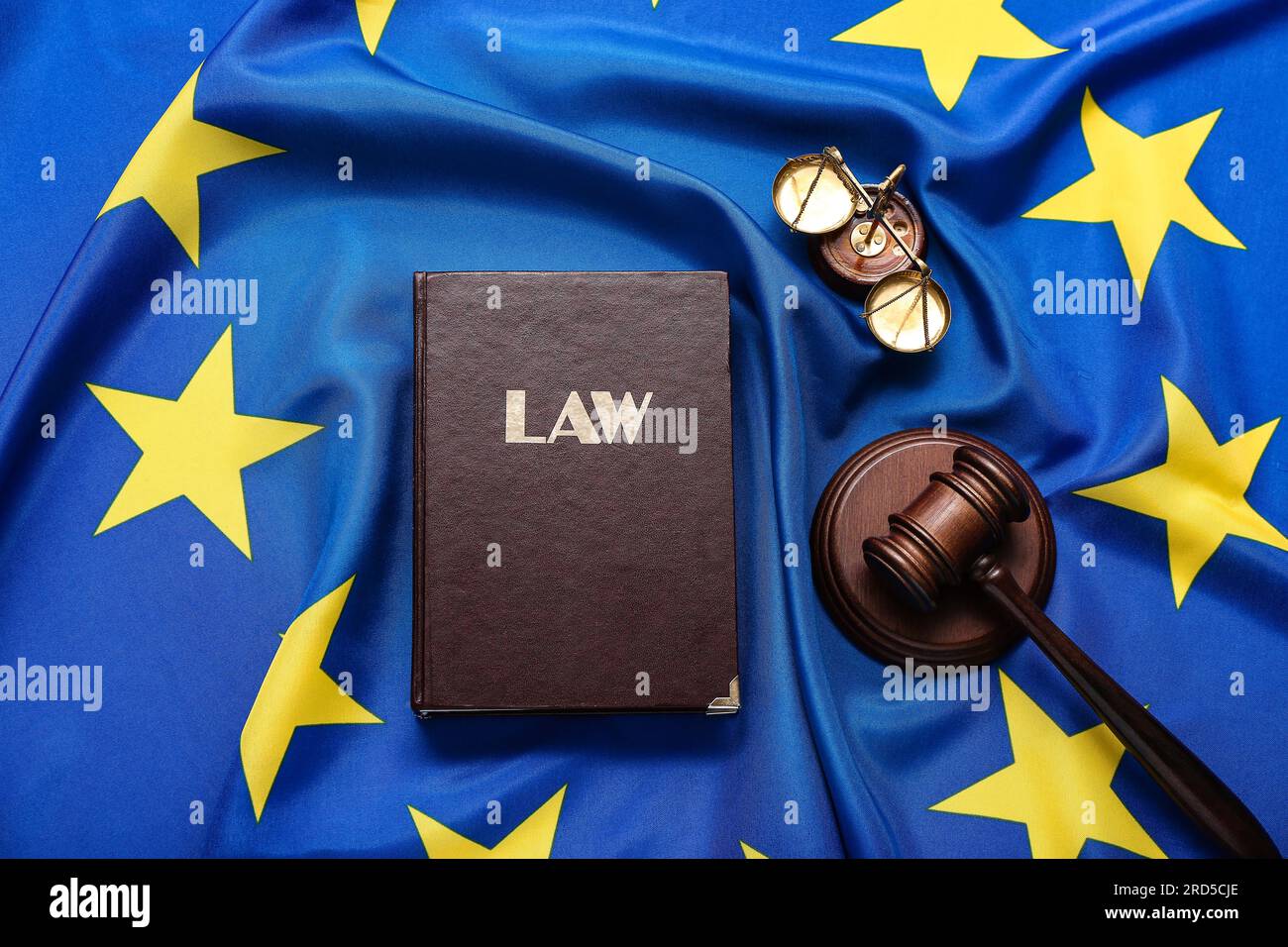 Law book, scales of justice and judge's gavel on European Union flag ...