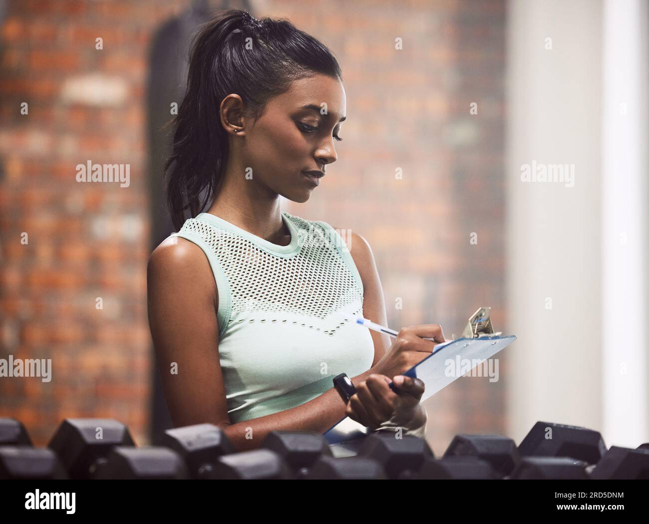 Entrepreneur, clipboard and woman in a gym, inventory and exercise with ...