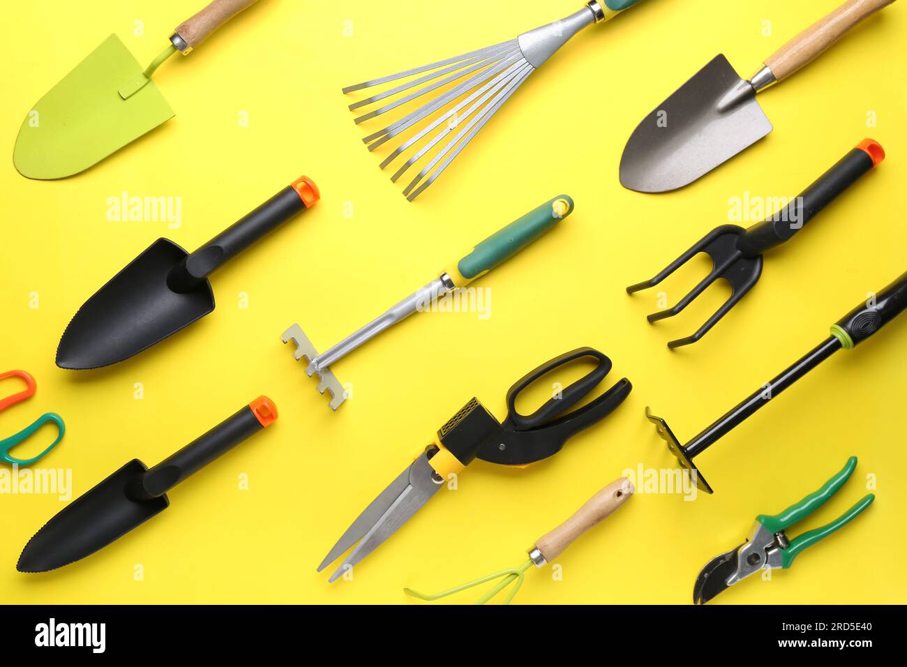 Set of different gardening tools on yellow background Stock Photo - Alamy