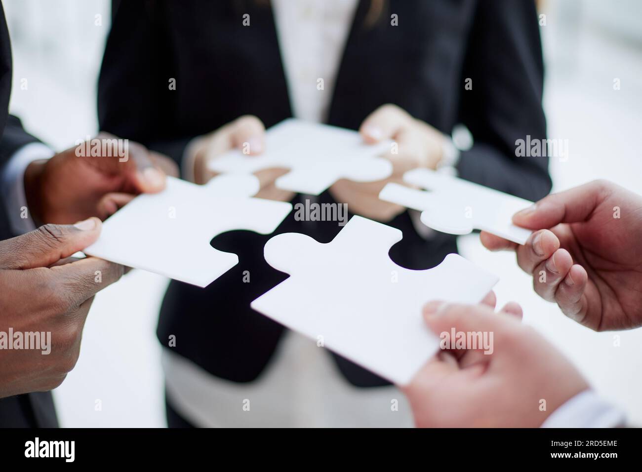 Group of business people assembling jigsaw puzzle and represent team ...