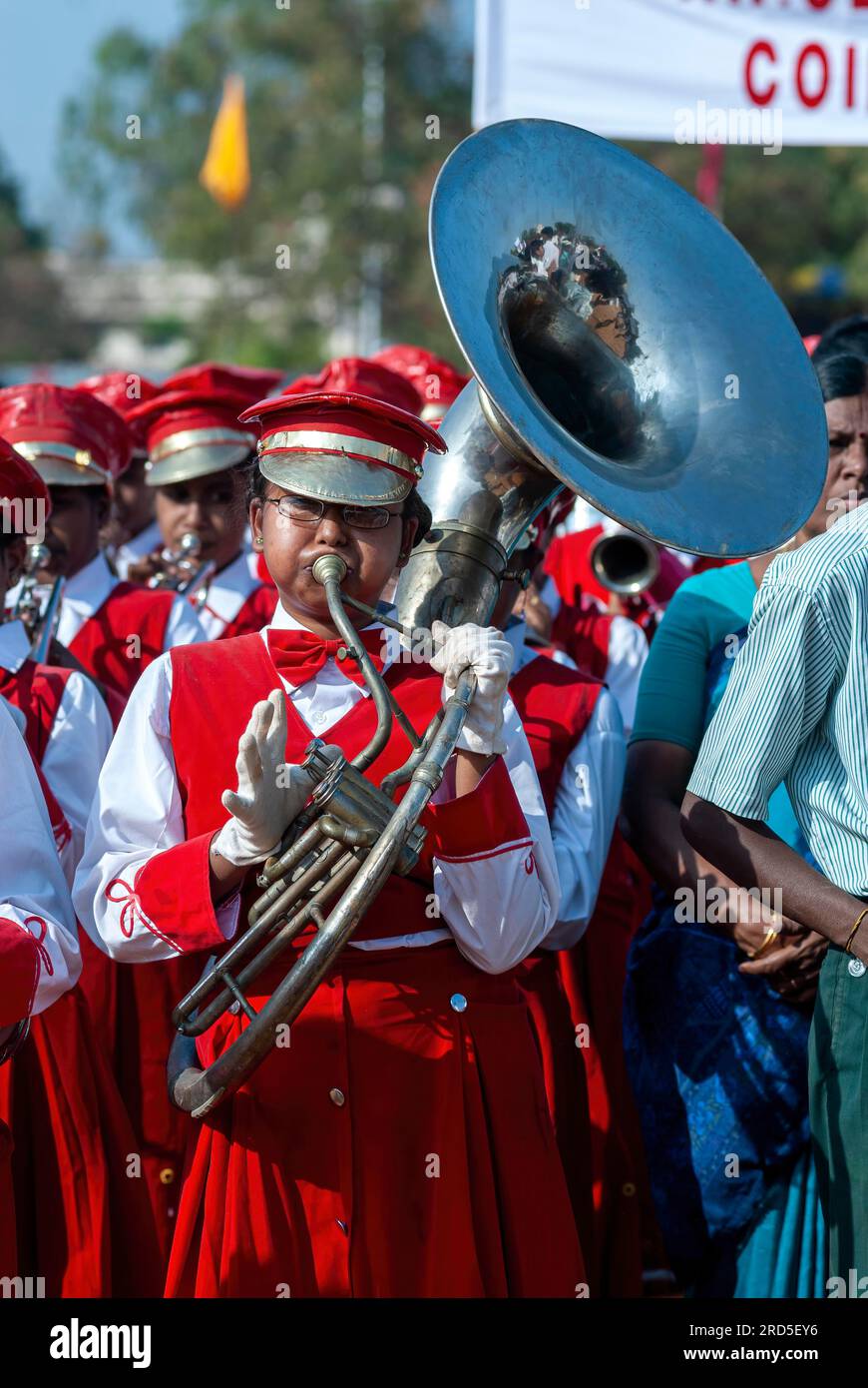 A girl in a music troop holding a big trumpet during independence day ...