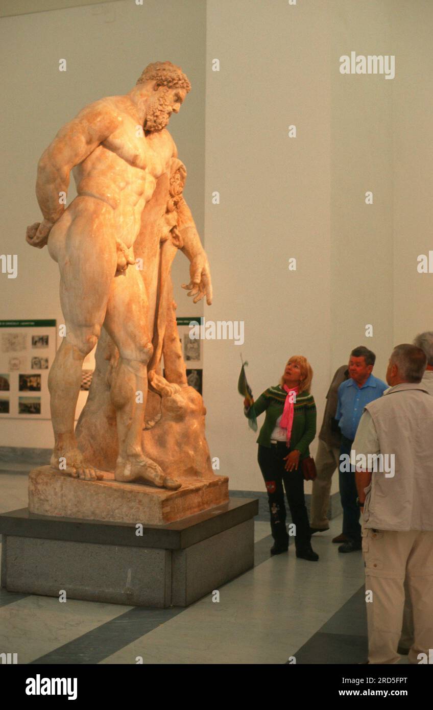 Visitor at sculpture 'Hercules Farnese', National Archaeological Museum ...