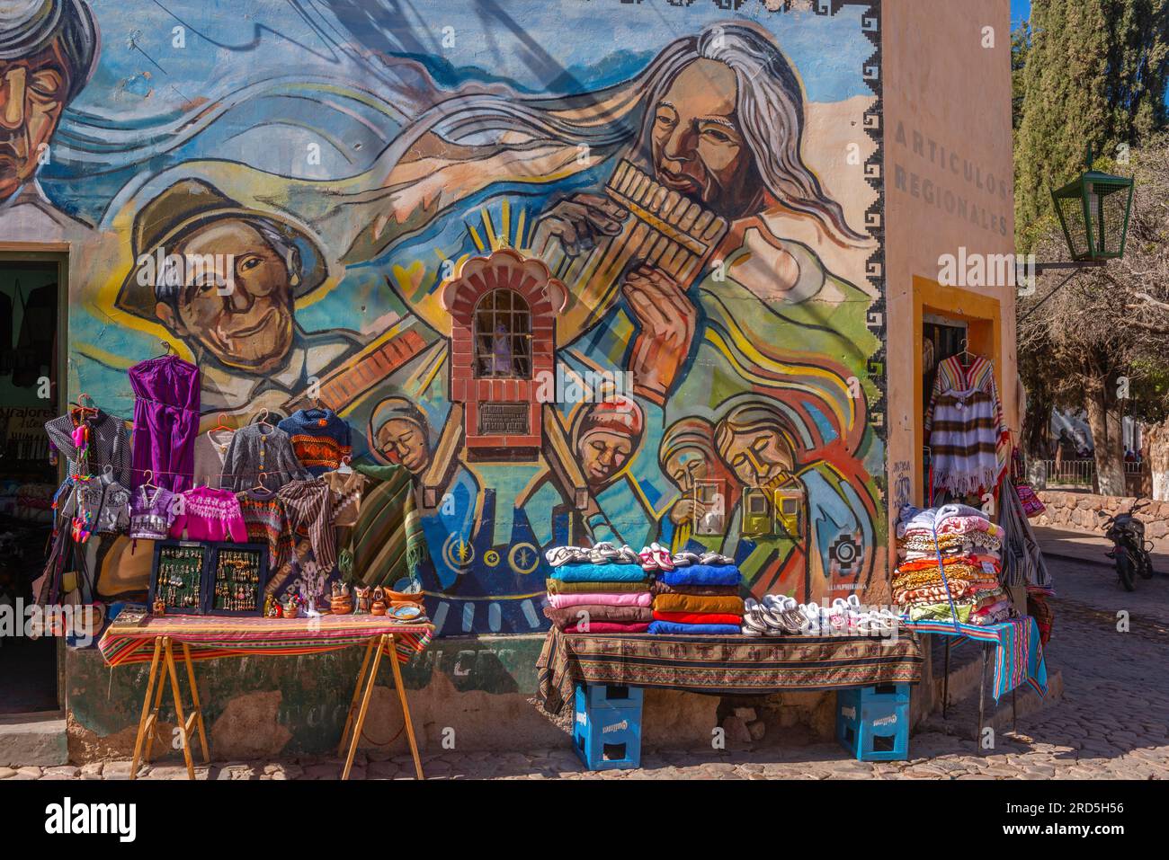 Street sale of textiles, artistic mural painting, Humahuaca village ...