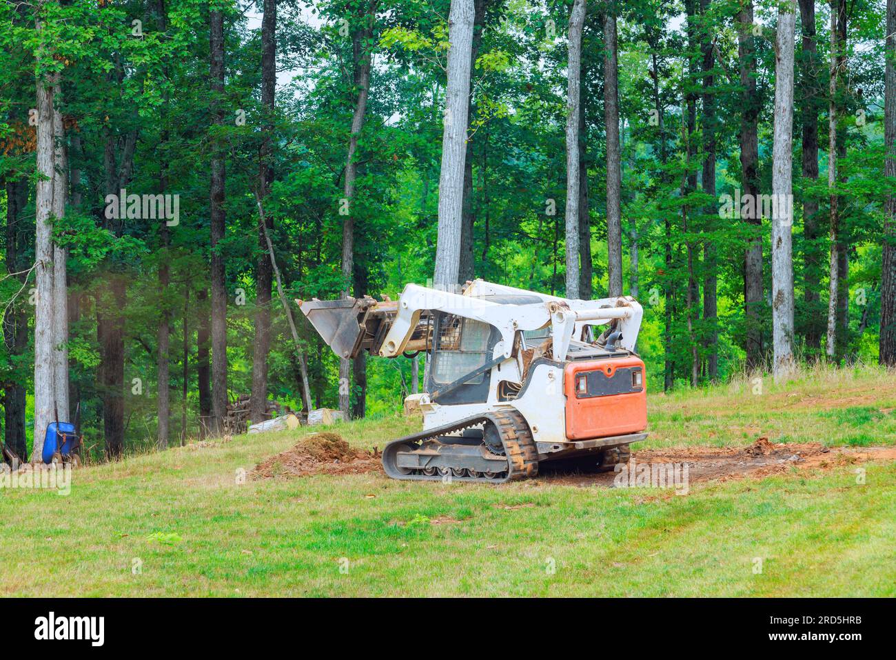 Ground is moved in bulldozer while landscaping work being performed ...