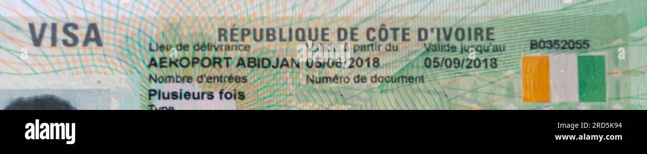 Côte d'Ivoire border crossing stamp in an open passport. Côte d'Ivoire ...