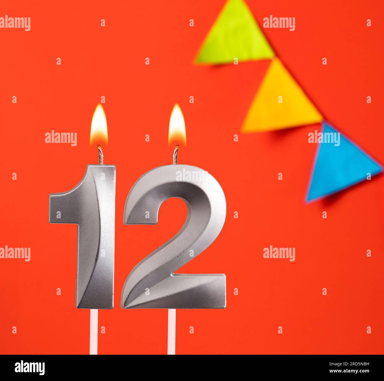 Birthday card - Number 12 candle in orange background Stock Photo - Alamy