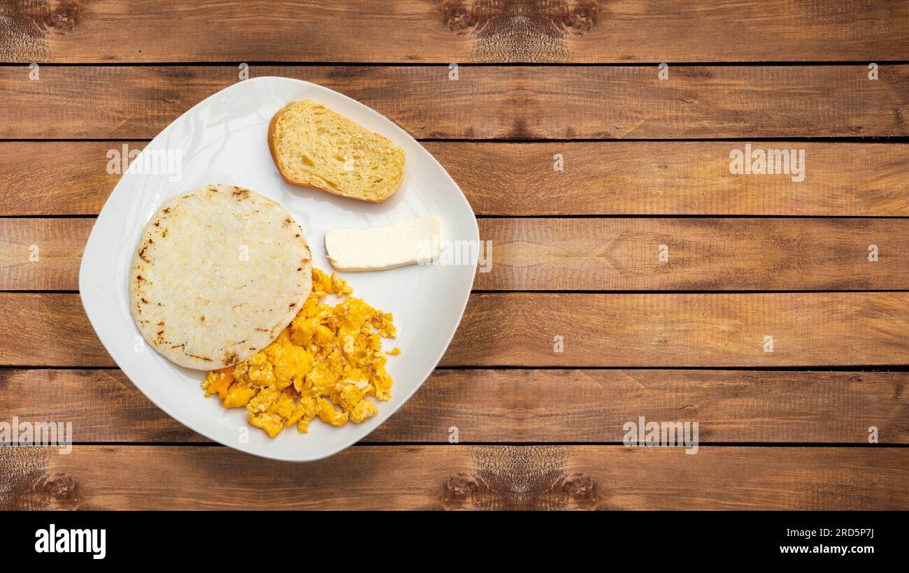 Traditional Colombian breakfast - Arepa with cheese, egg and bread ...